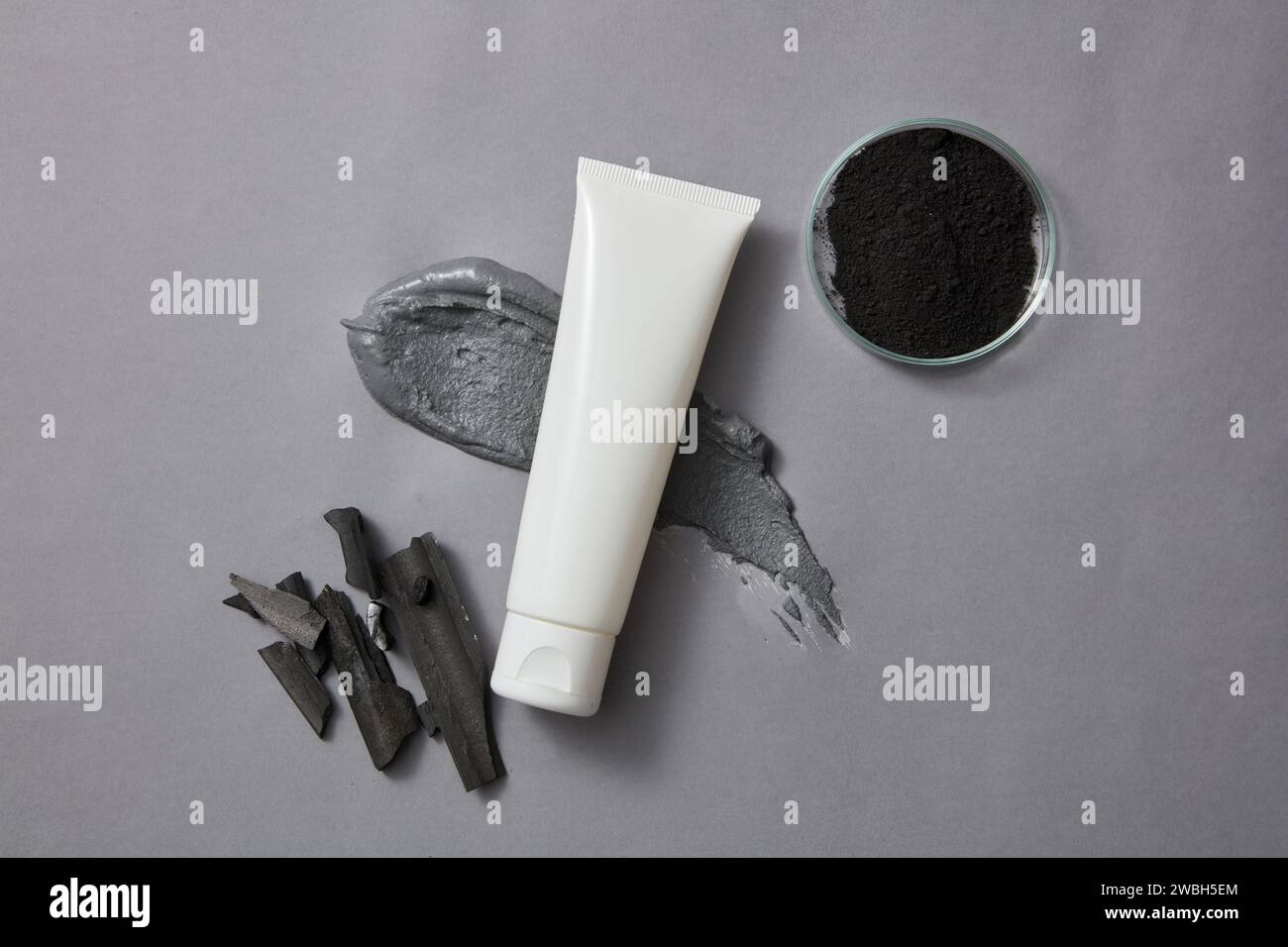 A tube without label is decorated with a smear of clay mask and a petri ...