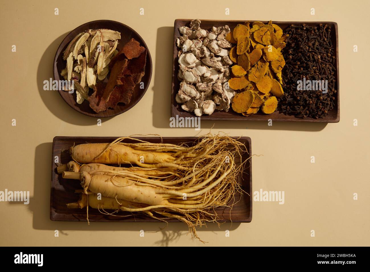 Many types of herbal medicine are displayed on wooden dishes in ...