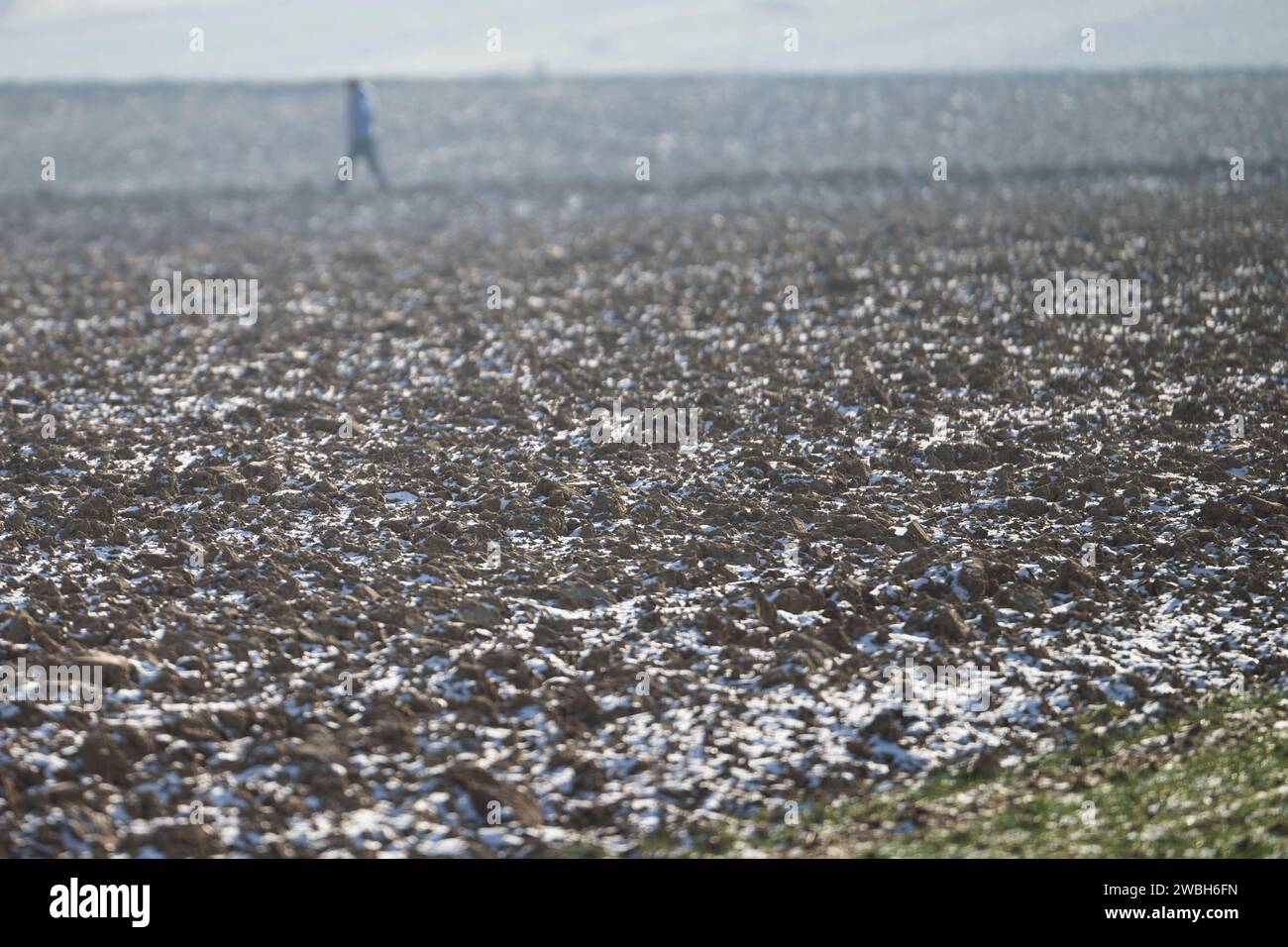Leinfelden, Germany. 10th Jan, 2024. Arable soil is covered in ice ...