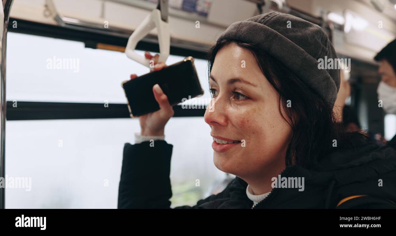 Woman, smartphone and thinking in train, travel and hand holding handle ...