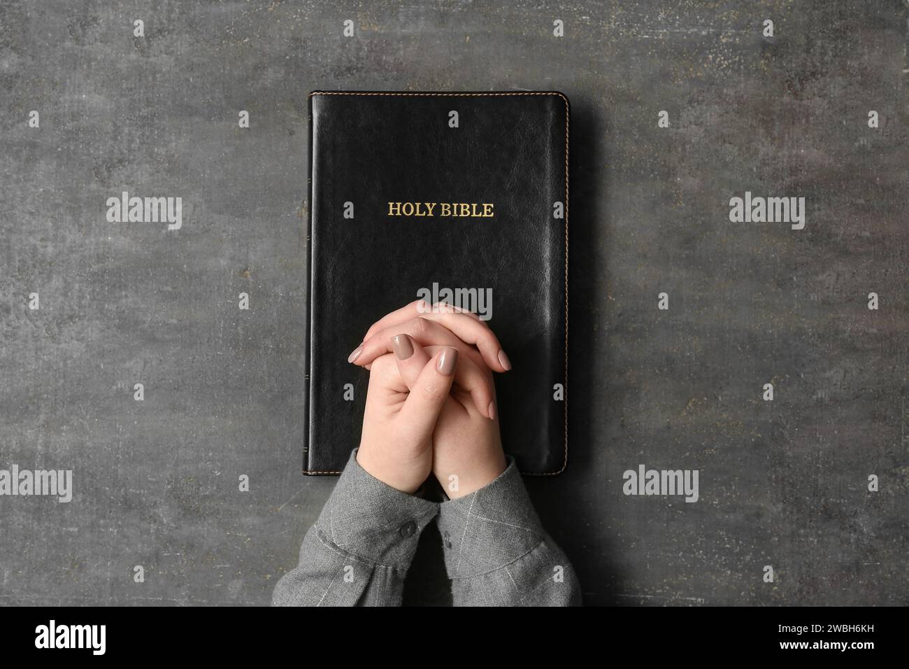 Woman with Holy Bible on grunge background Stock Photo - Alamy