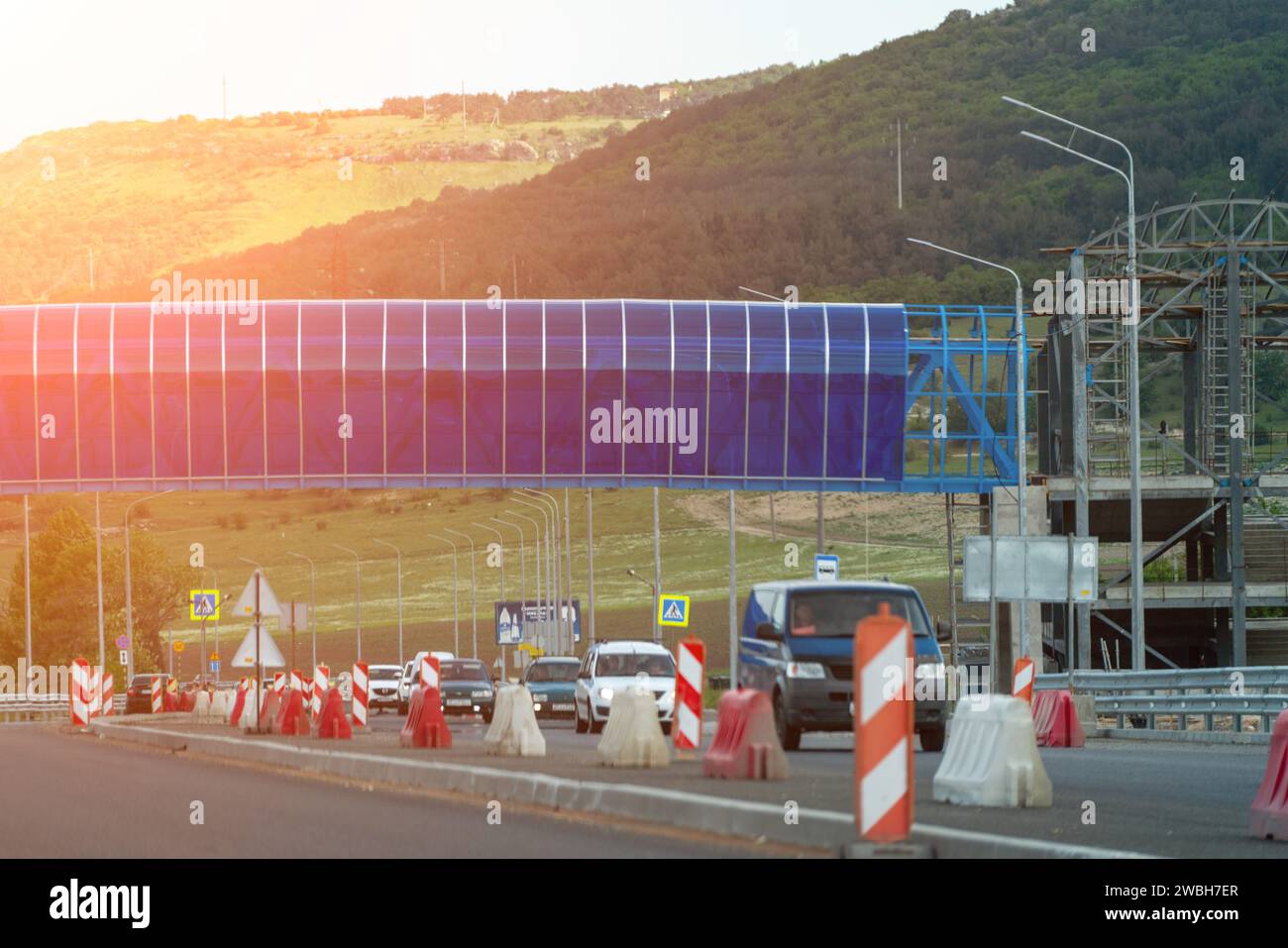 Red, white plastic safety barriers along road. Ensuring road safety ...