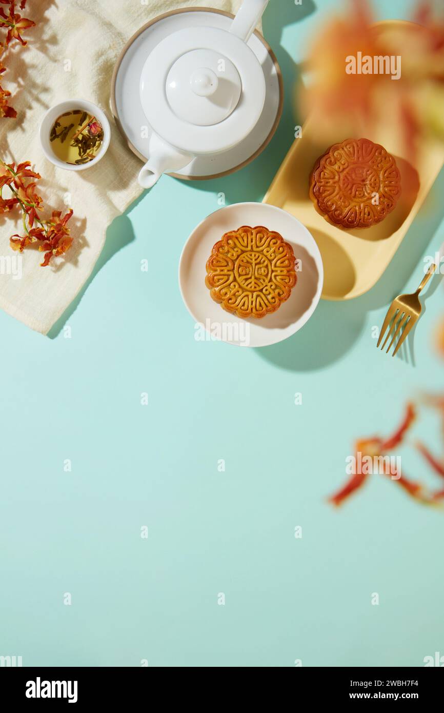 Delicious baked mooncakes decorated with a tea set placed on white ...