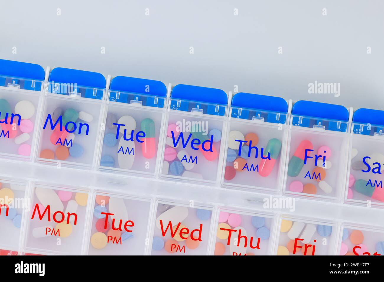 An weekly organizer box for dispensing medications on white background ...