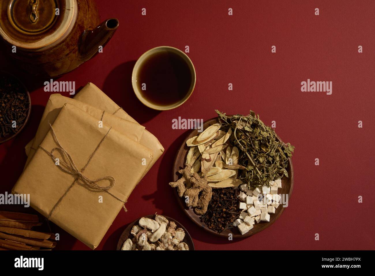 A bowl filled with tonic arranged with an earthen pot, packs of ...