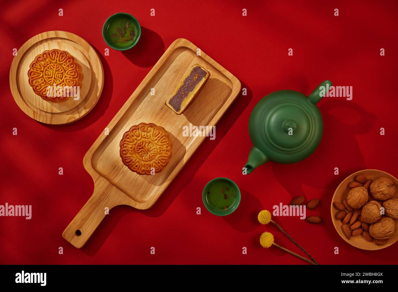 Traditional mooncakes, almond nuts and walnuts are placed on wooden ...