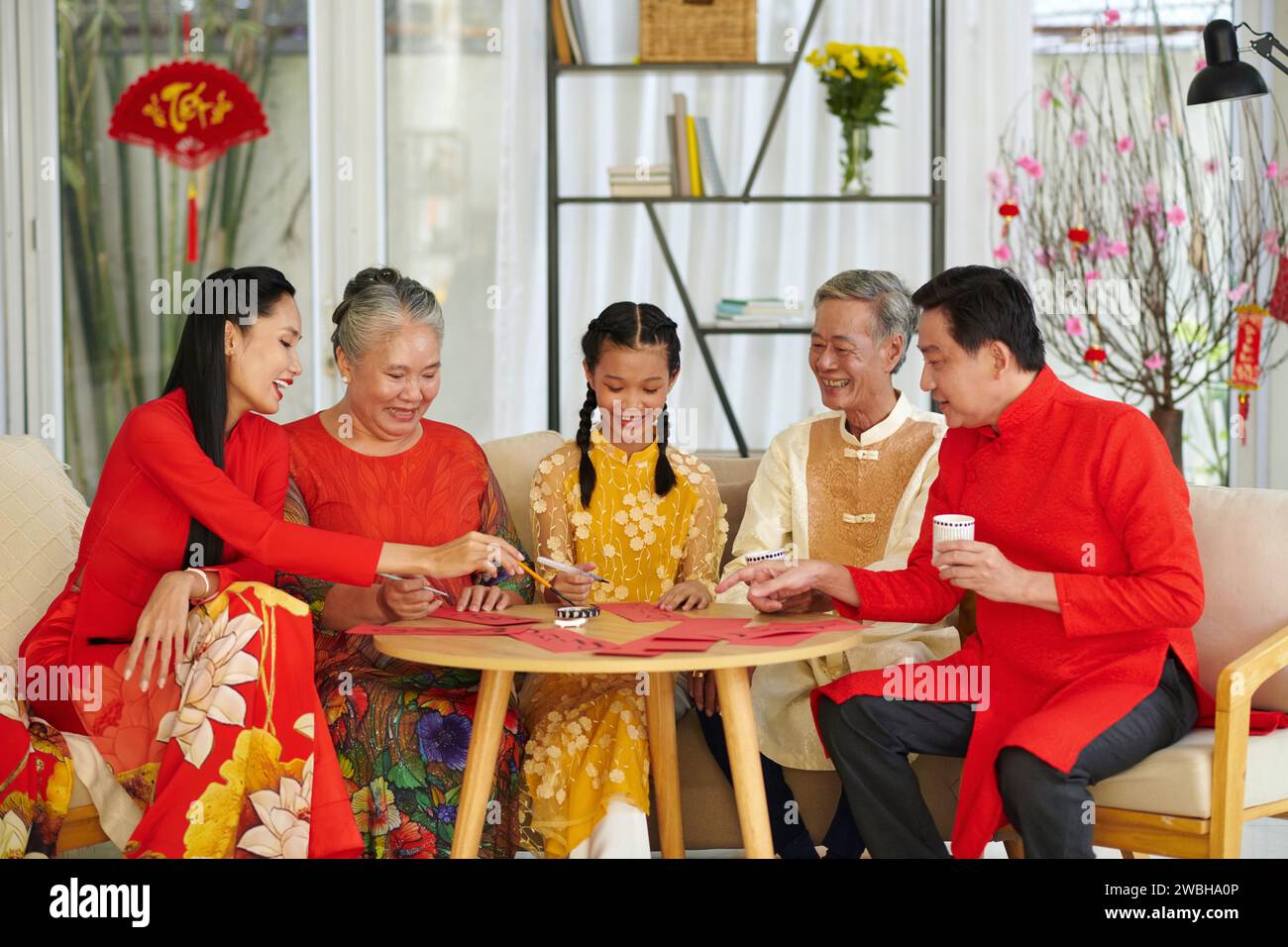 Big Vietnamese family gathered together to write calligraphy couplets ...