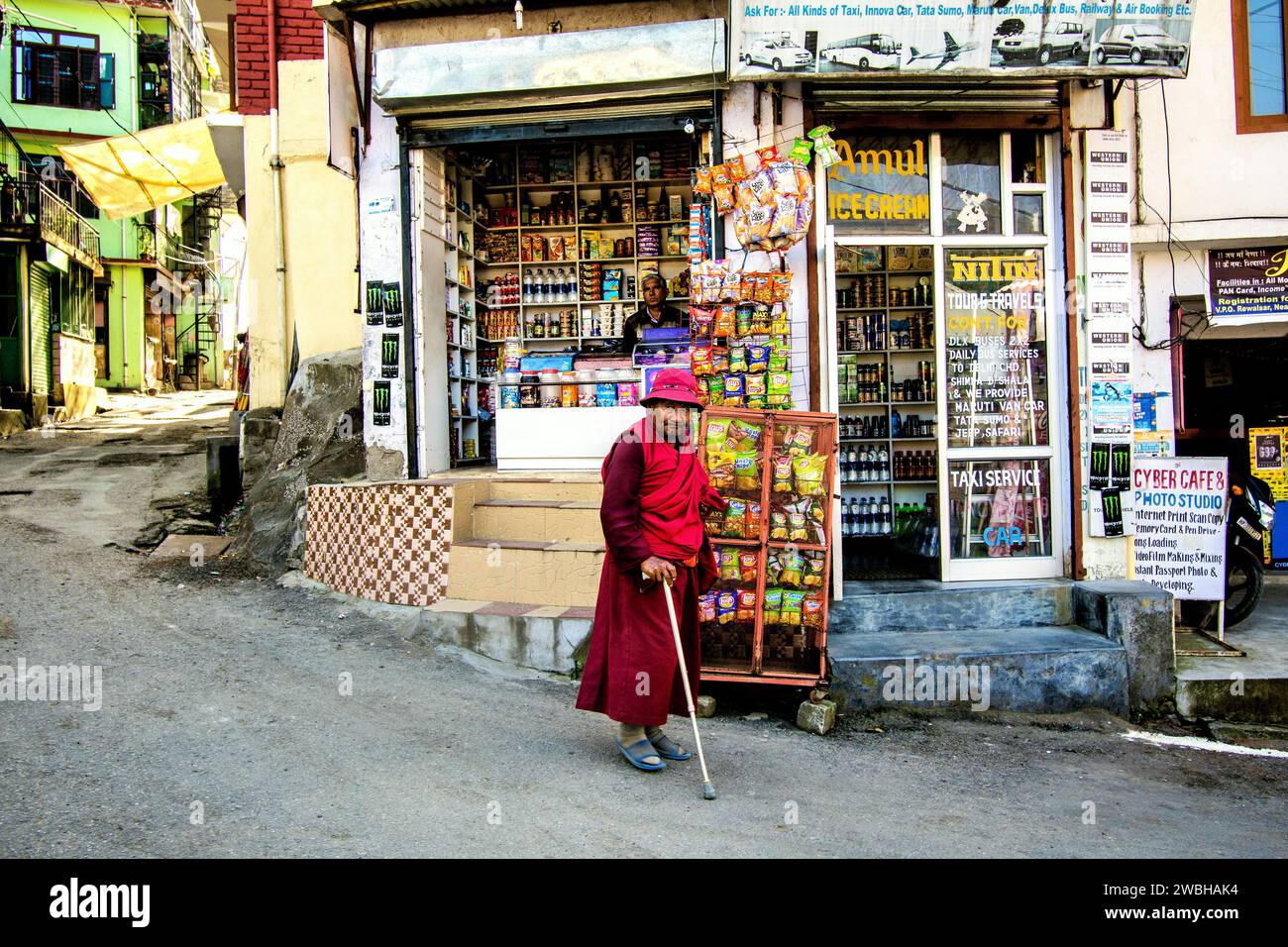 Old Lama walking with stick, market street, Rewalsar, Nagar, Mandi ...