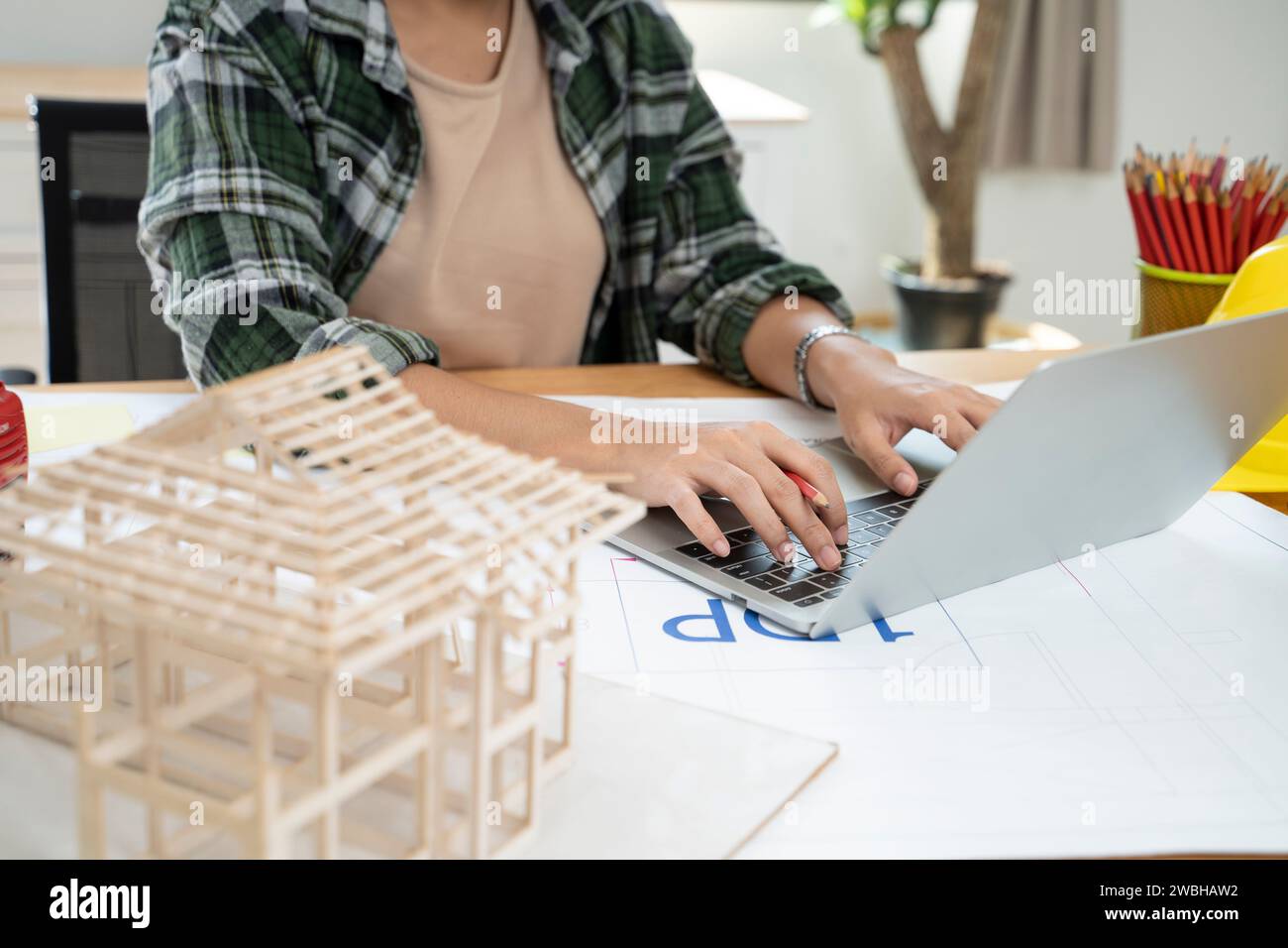 Asian architect woman working with laptop and blueprints Stock Photo ...
