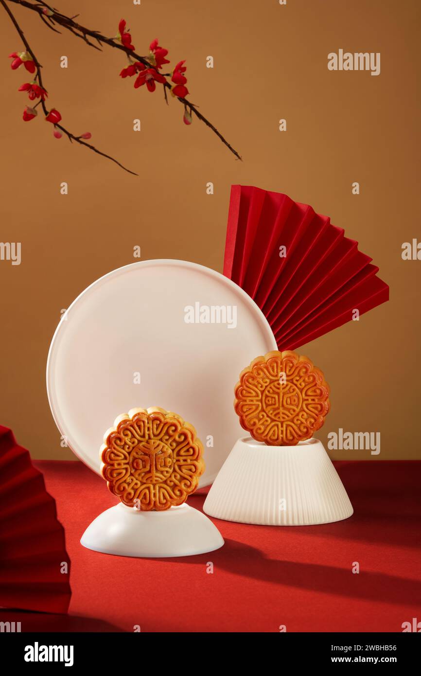 Red origami paper decorated with traditional mooncakes and branches of ...