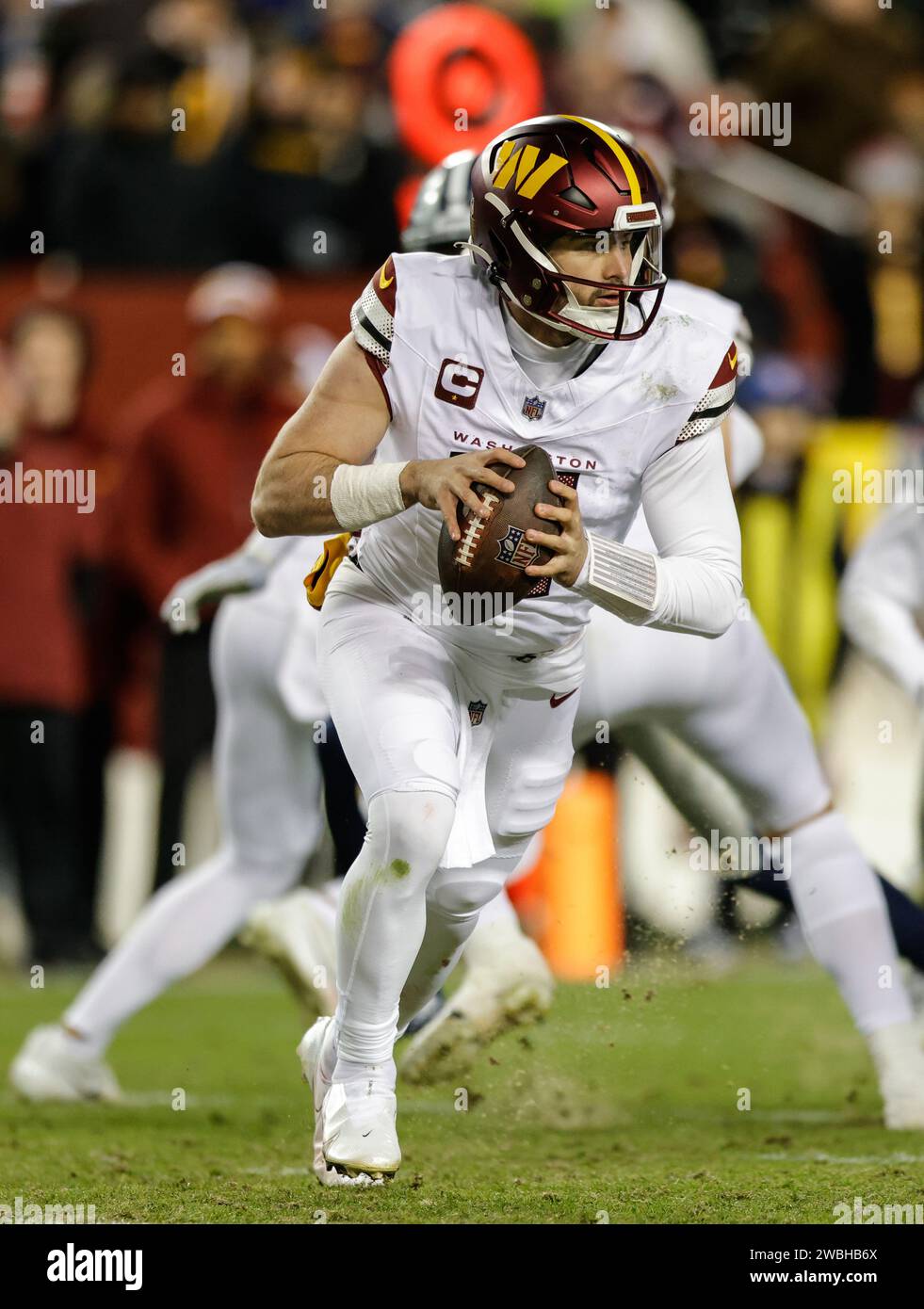 Washington Commanders quarterback Sam Howell (14) with the carry ...