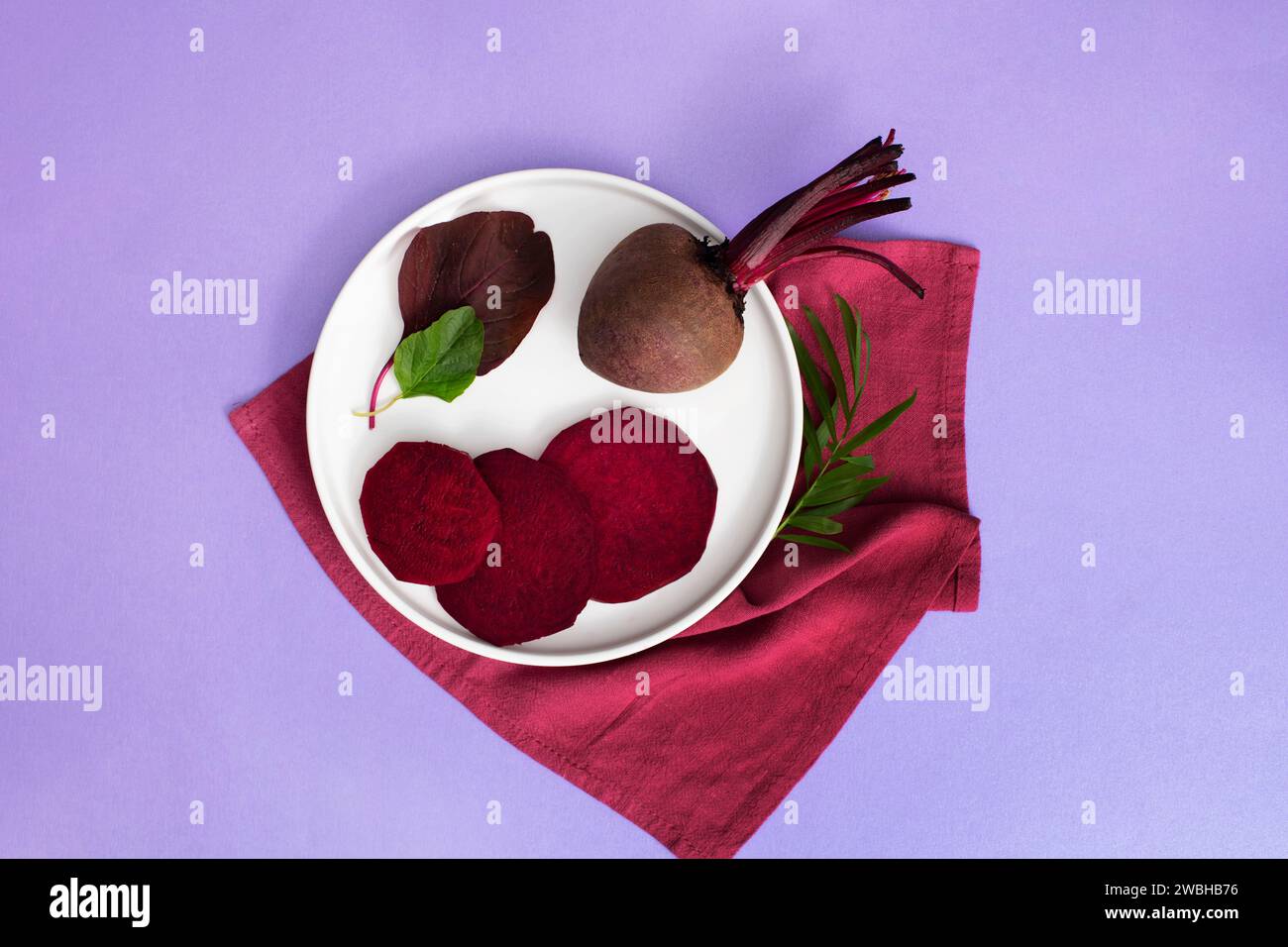 A round dish in white color featured some slices of beetroot and fresh ...