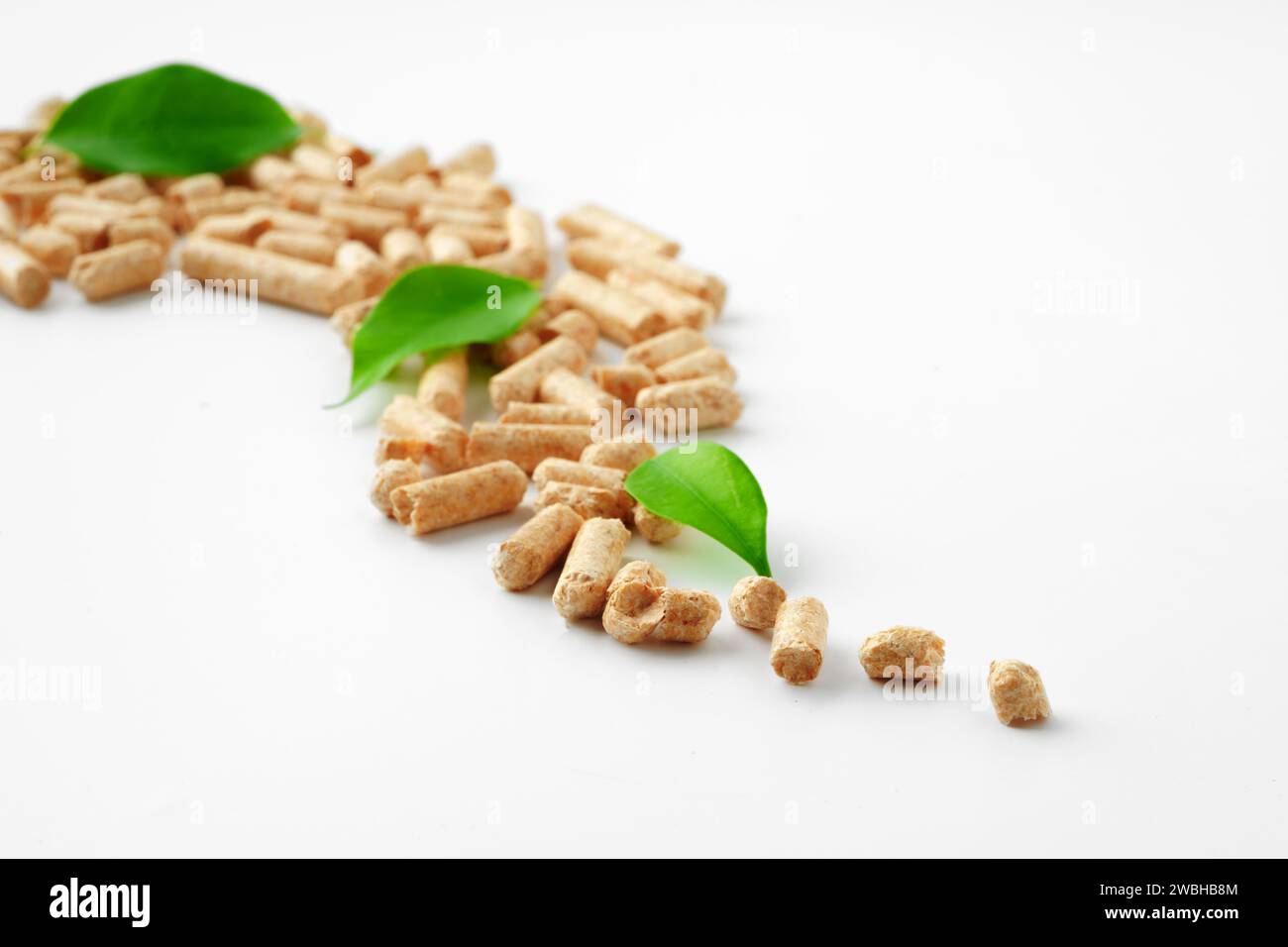 Wood pellets biofuel isolated on white background Stock Photo - Alamy