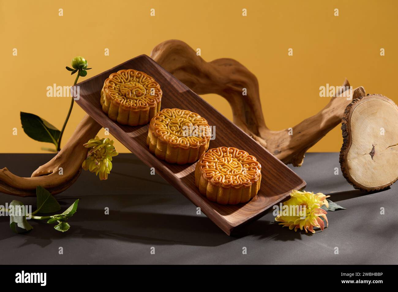 Rectangle wooden dish featured three beautiful mooncakes. A big tree ...