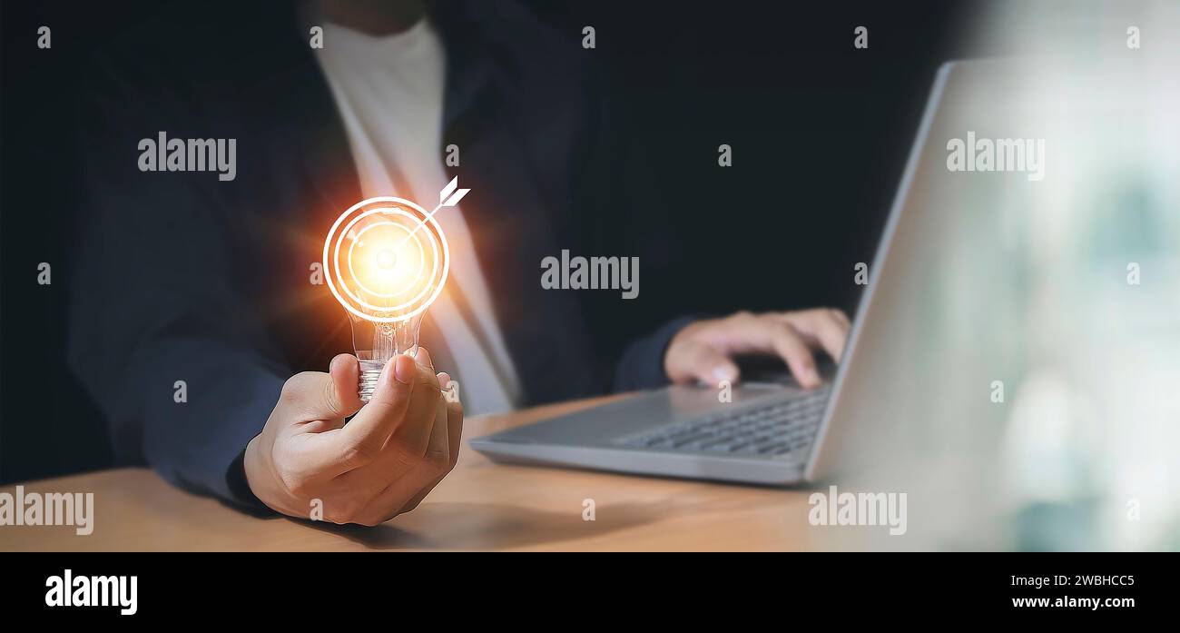 Businessman Holding An Innovative Light Bulb Creating New Ideas Inspirational Ideas And Problem
