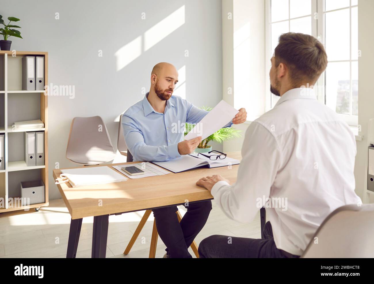 Man interviewing new candidate for vacancy company sitting in office ...
