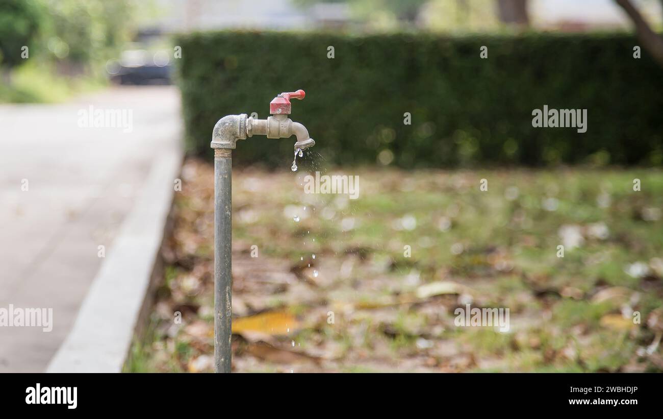 Old faucet outside the house dripping Stock Photo - Alamy