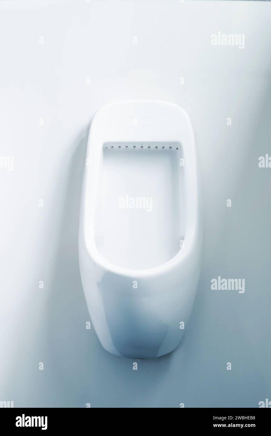 White urinals on a white wall Stock Photo - Alamy
