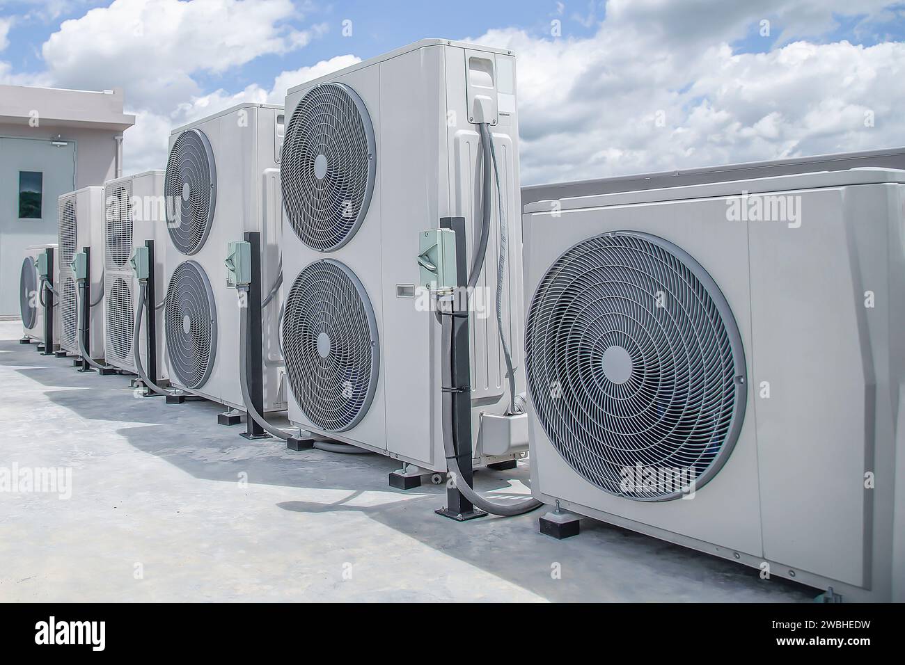 Air conditioning (HVAC) on the roof of an industrial building with blue ...