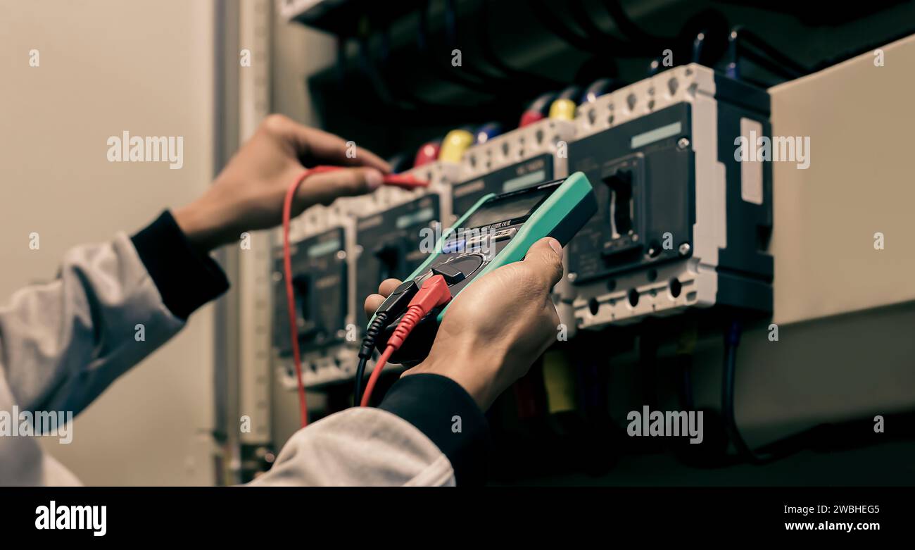 Electrician engineer work tester measuring voltage and current of power ...