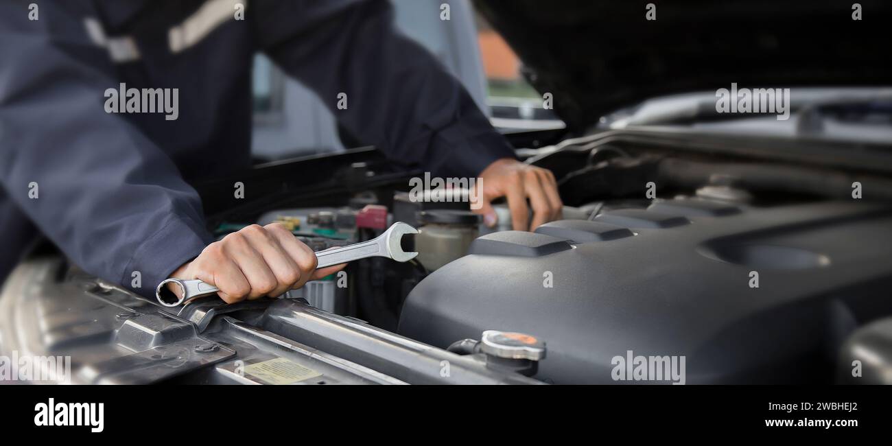 Car mechanic working on car engine, car maintenance concept Stock Photo ...