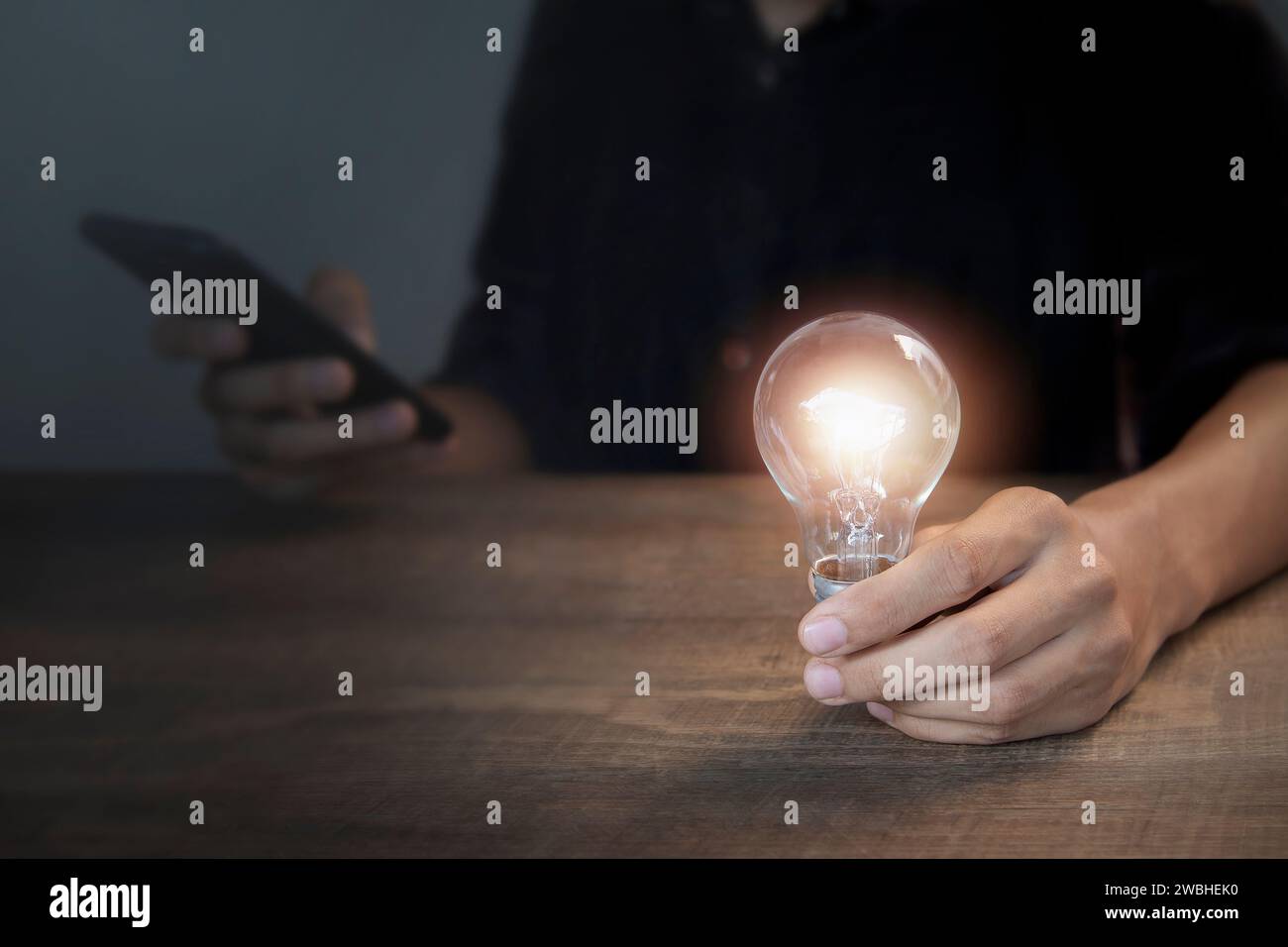 businessman holding an innovative light bulb creating new ideas inspirational ideas and problem ...