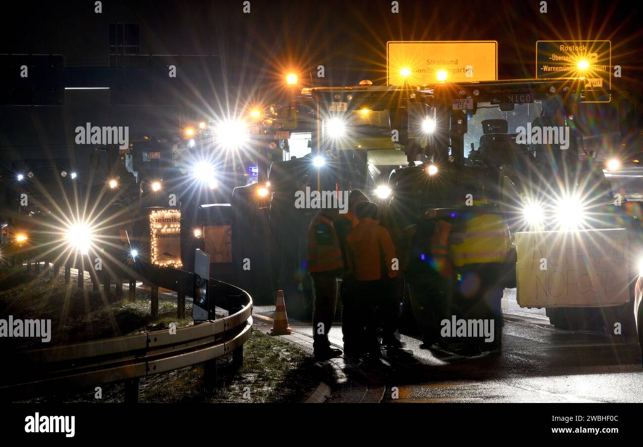 Rostock, Germany. 11th Jan, 2024. Convoys of tractors block the Rostock ...