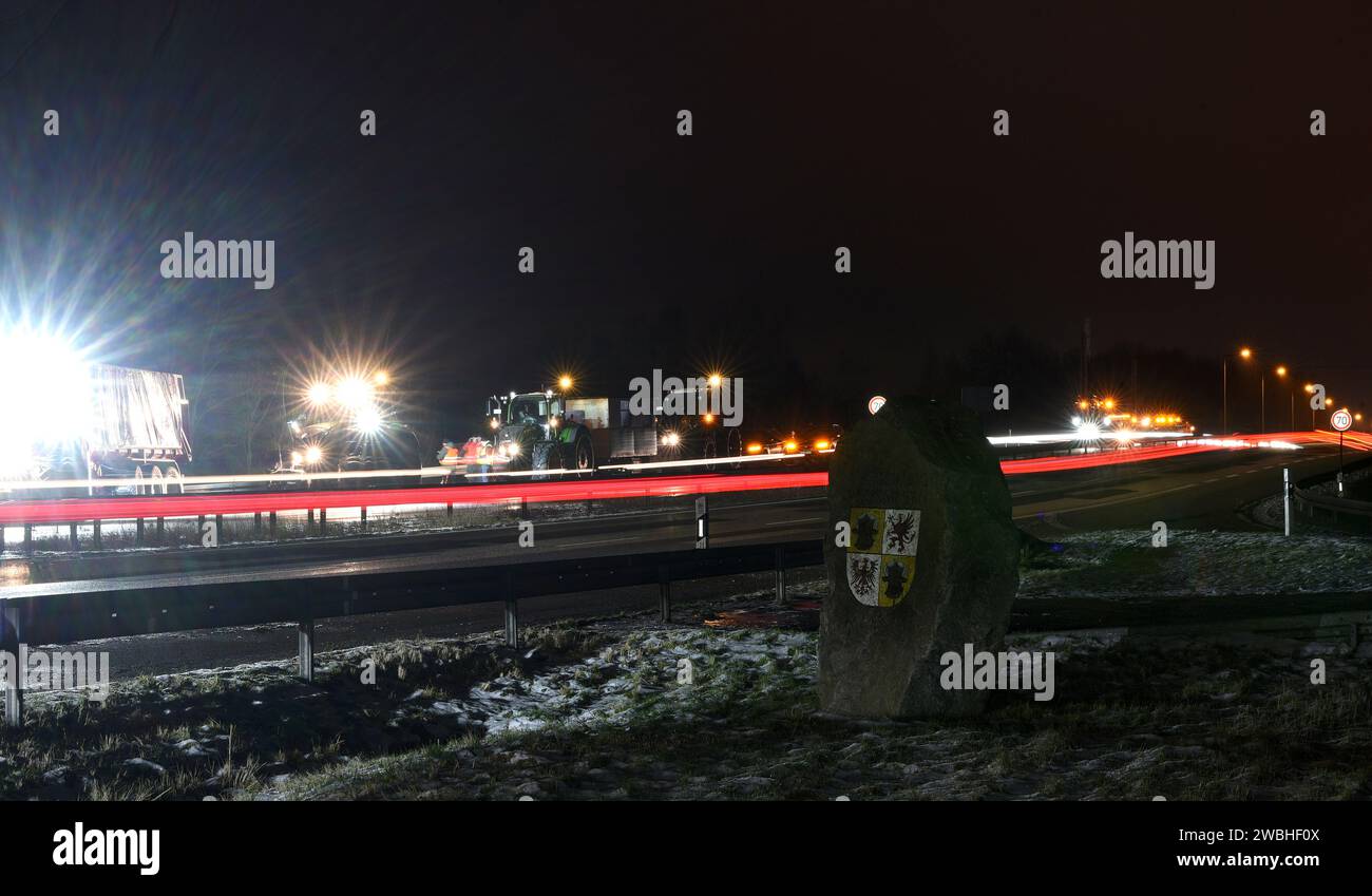 Rostock, Germany. 11th Jan, 2024. Convoys of tractors block the Rostock ...