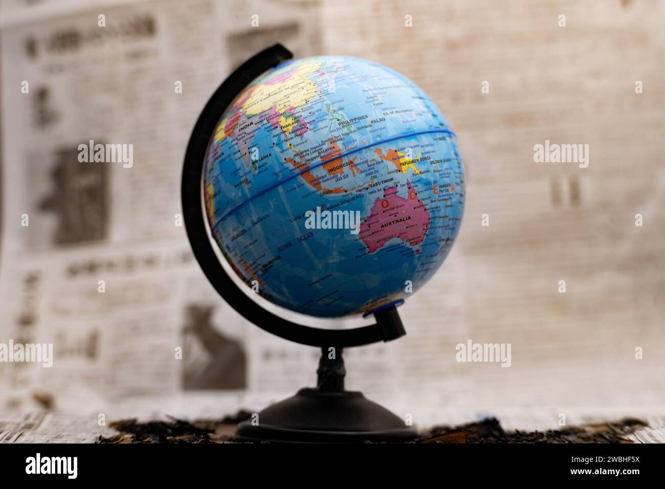 Model globe on a newspaper in the background Stock Photo - Alamy