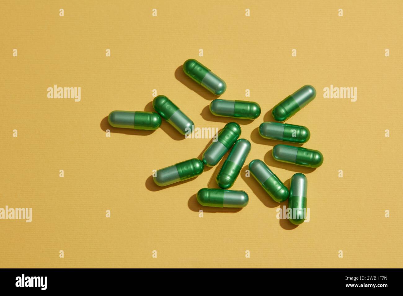 Top view of a lot of capsules pills on a yellow background. Sample ...