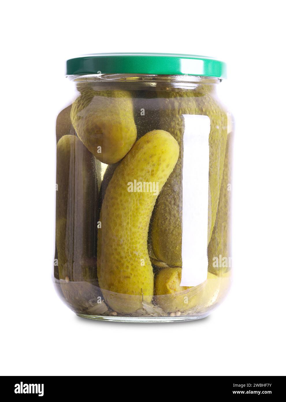 Whole gherkins, pickled cucumbers, in a glass jar. Crunchy pickles ...