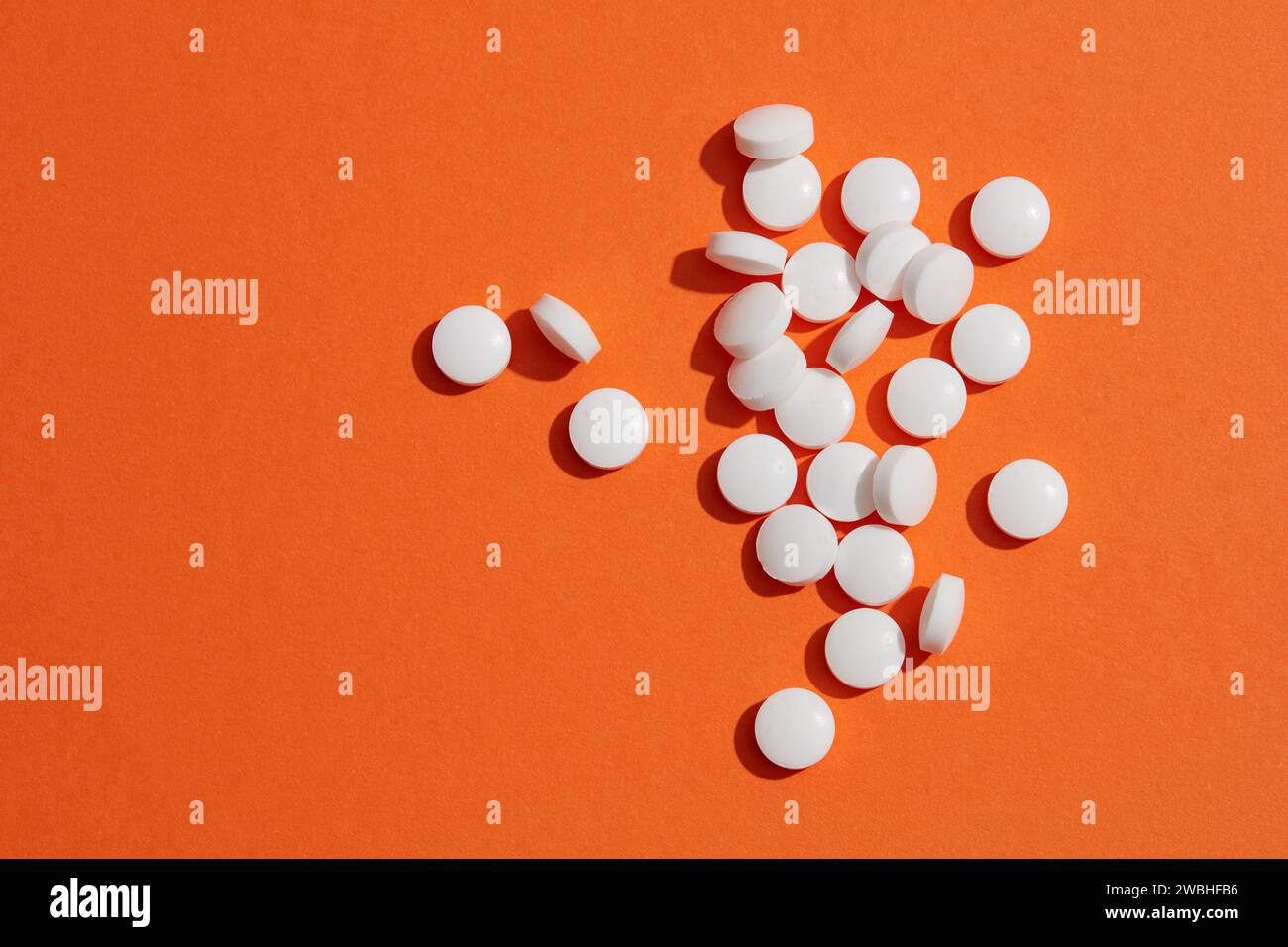Tablets and caplets pills pharmaceutical dosage form on orange ...
