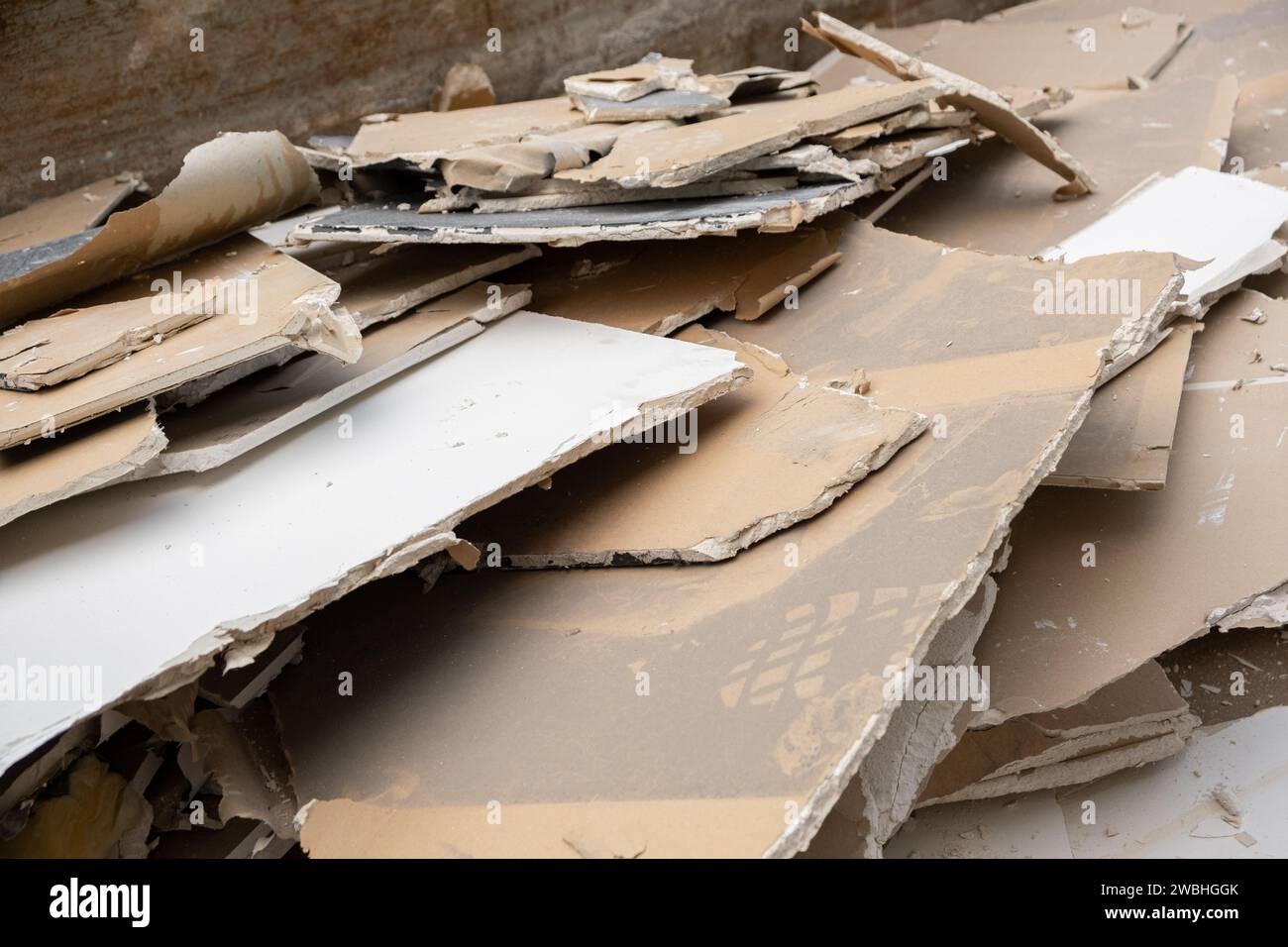 Ruined drywall plasterboard. dumpster waste container with construction ...