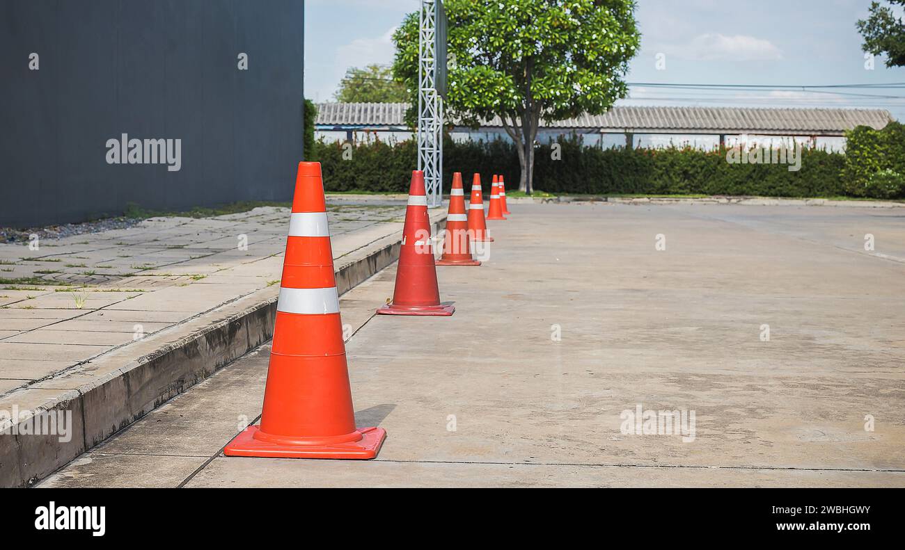 Orange traffic cones on concrete road Stock Photo - Alamy