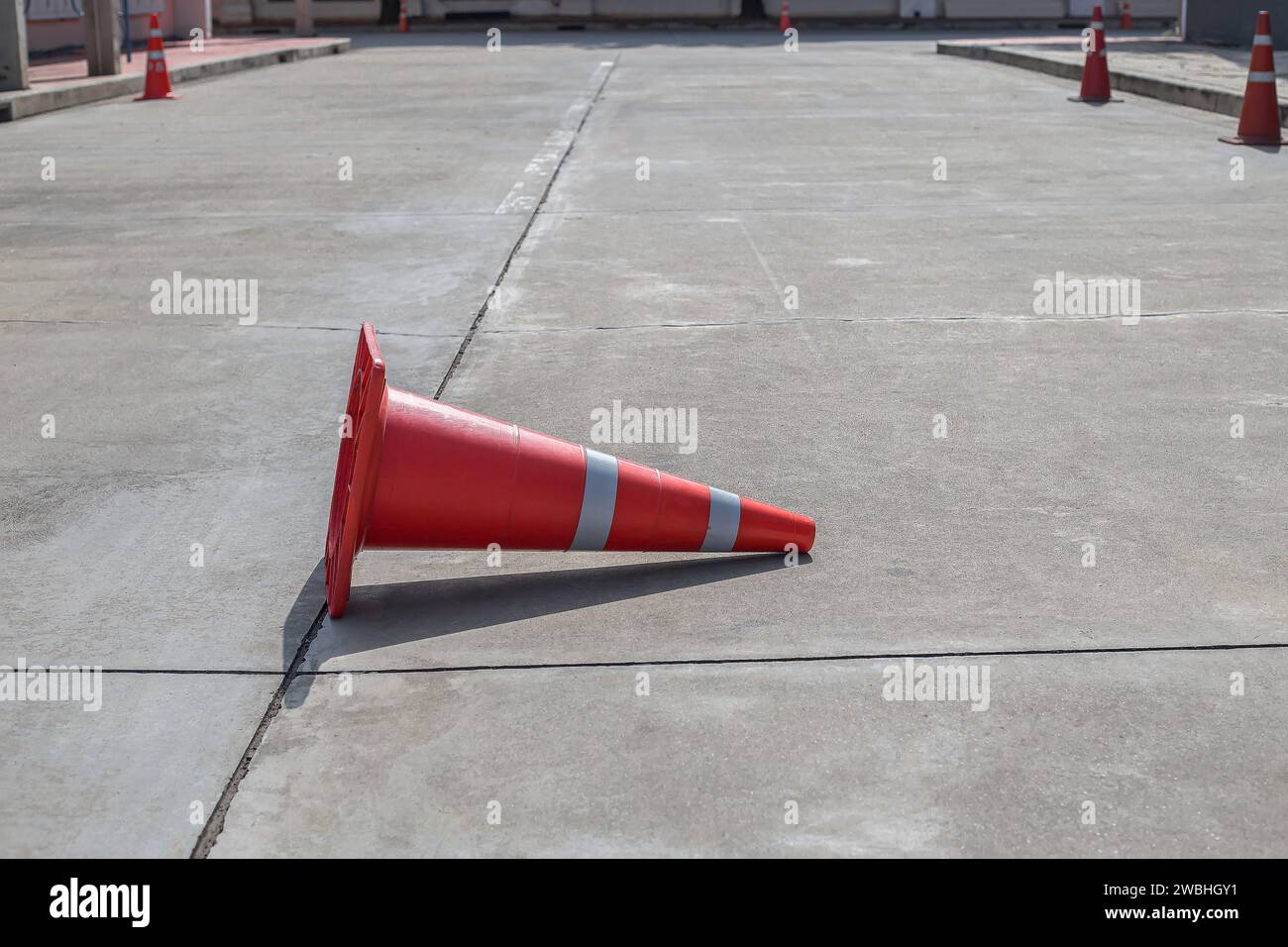 Orange traffic cones on concrete road Stock Photo - Alamy