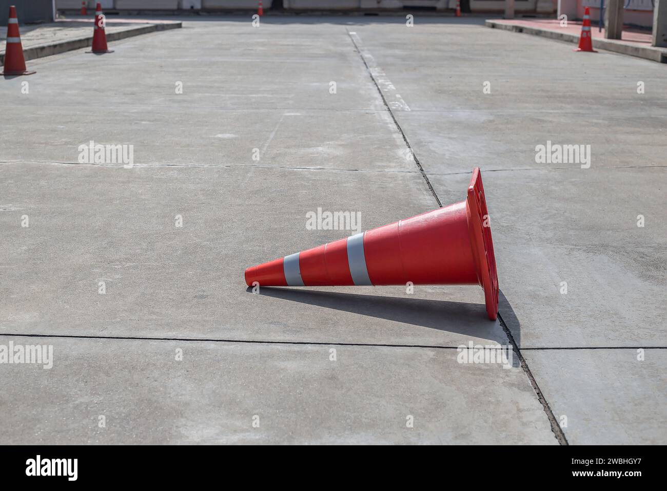 Orange traffic cones on concrete road Stock Photo - Alamy