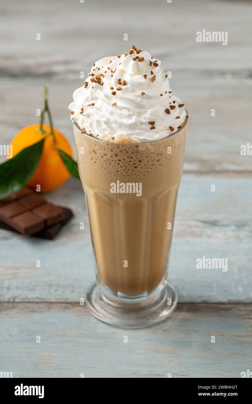Orange and chocolate milkshake with coffee sprinkled on top Stock Photo ...