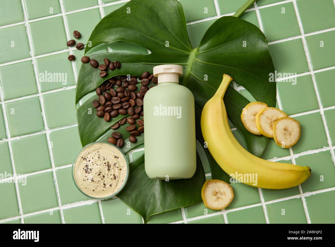 Top view of banana slices, roasted coffee beans, a bottle and a petri ...