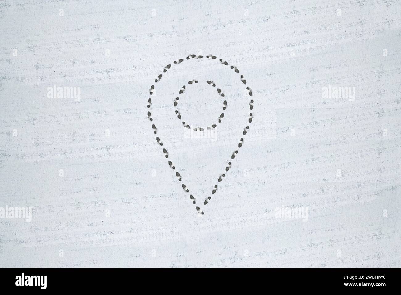 Footprints in snow forming a pin Stock Photo - Alamy