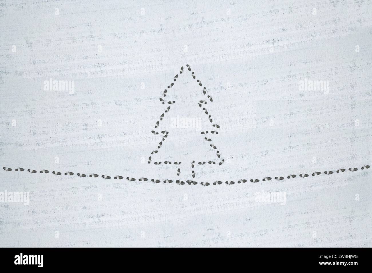 A footprints forming a tree in snow Stock Photo - Alamy