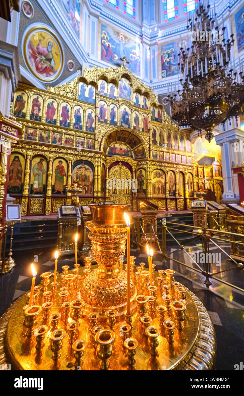 A few memorial candles are lit with the richly painted gold altar in ...
