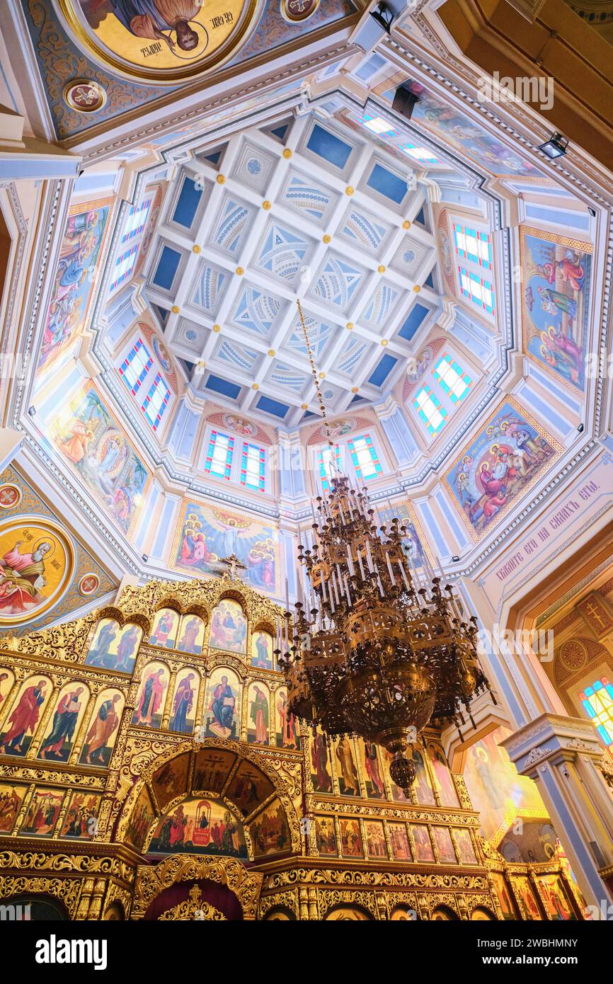 A view of the gold altar with soaring, white interior dome ceiling that features religious ...