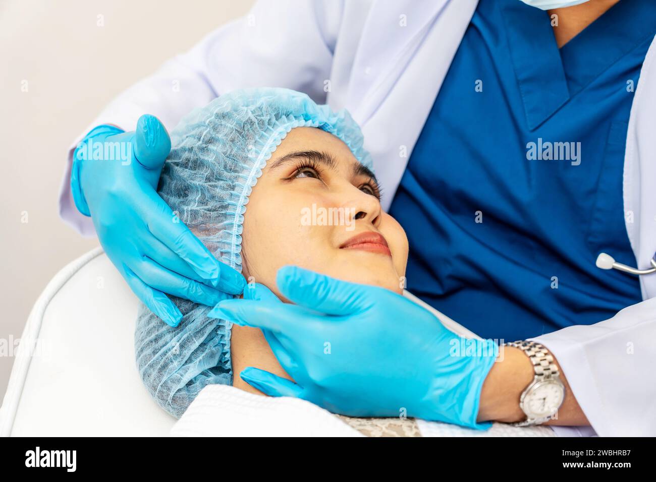 Cosmetic Surgeon Examines Beautiful Woman's Face, Touches it with ...