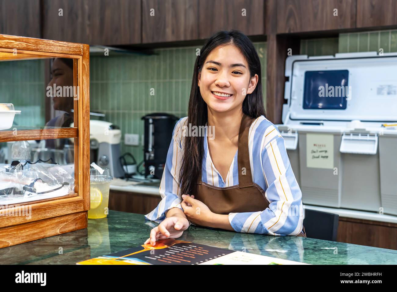 Welcoming guests, Portrait of cheerful young asian professional barista or businesswoman owning ...