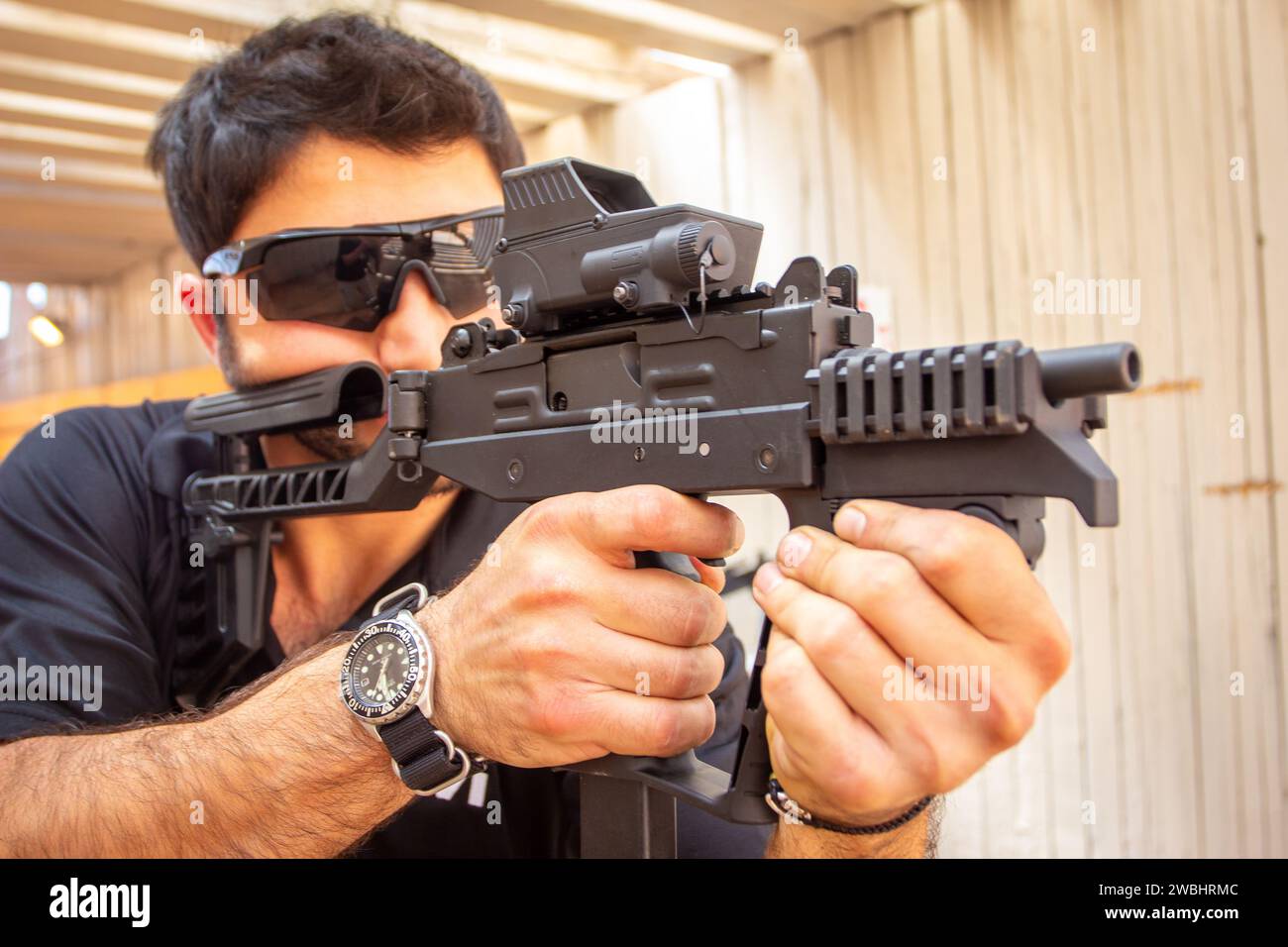 A man using IWI (Israel Weapon Industries) firearms in a show Stock ...