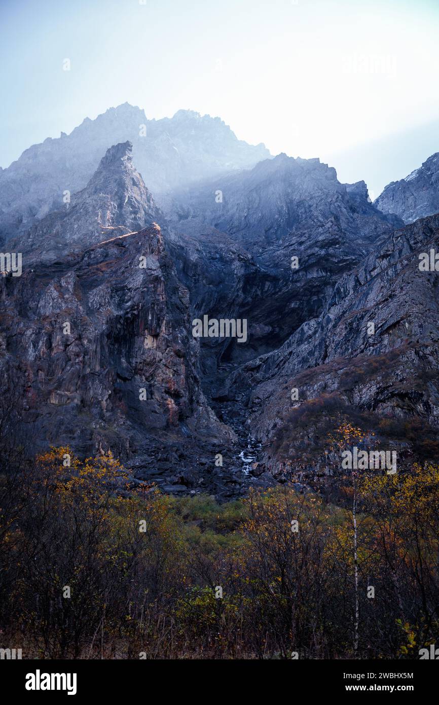 A breathtaking landscape with majestic rocky mountains, shrouded in the ...