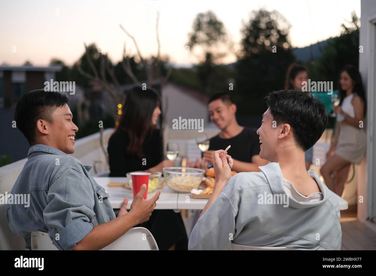 Group of friends hanging out together talking and having fun on a ...