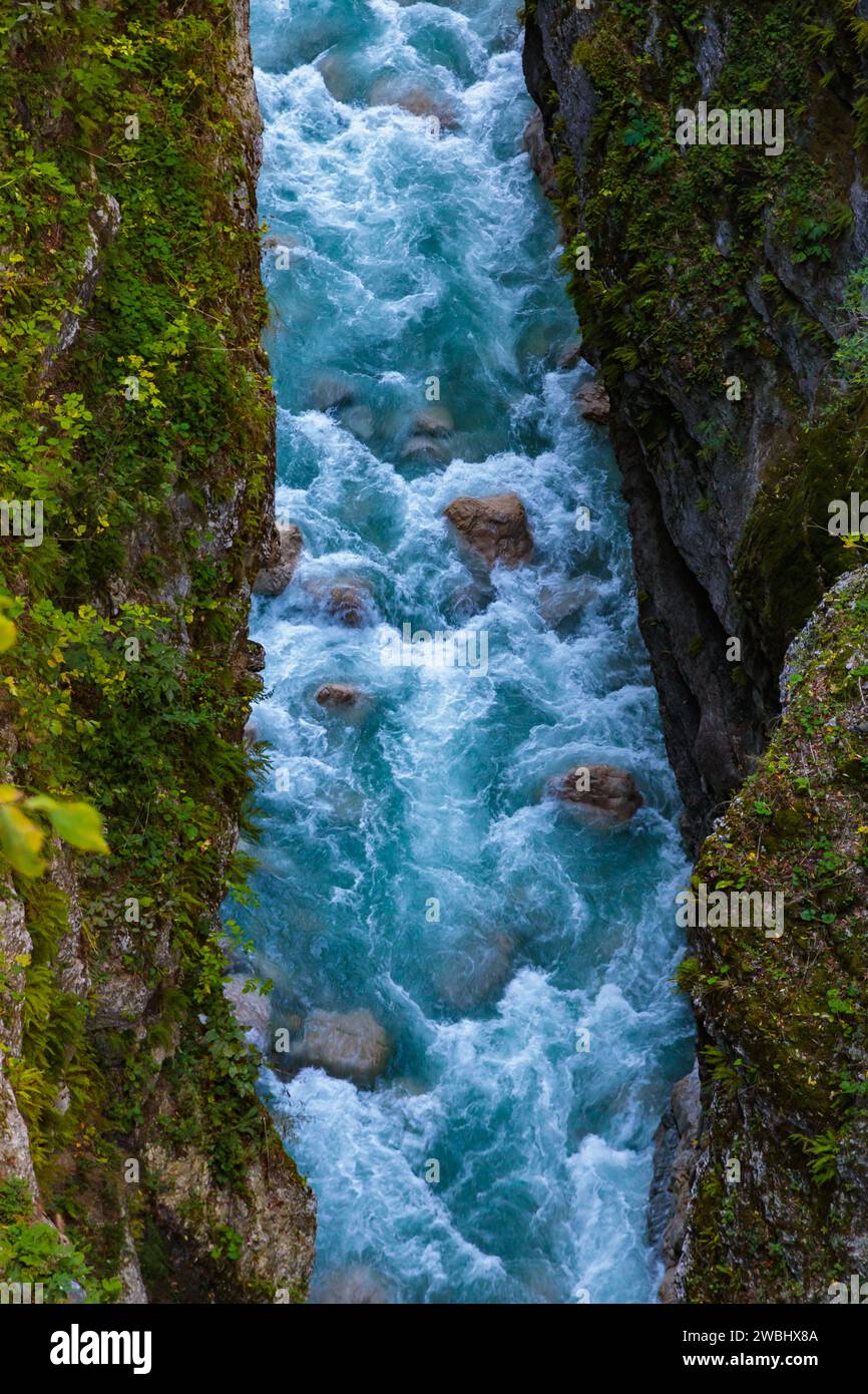 A picturesque gorge with a powerful flow of river water and mountain ...