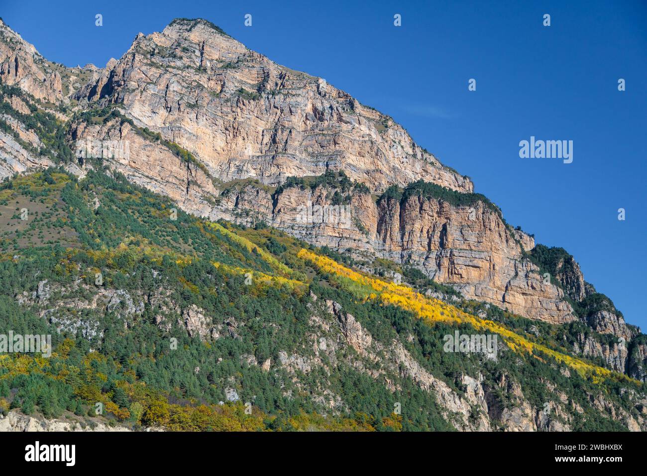 A breathtaking landscape with majestic rocky mountains, shrouded in the ...