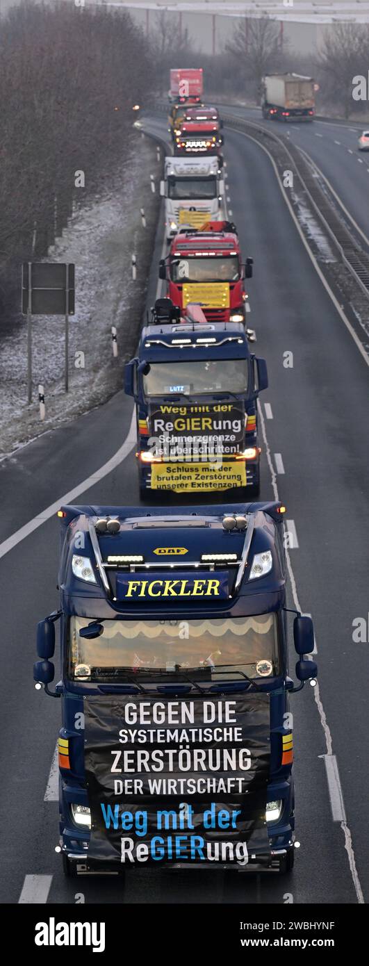 Vieselbach, Germany. 11th Jan, 2024. Trucks with banners drive in ...